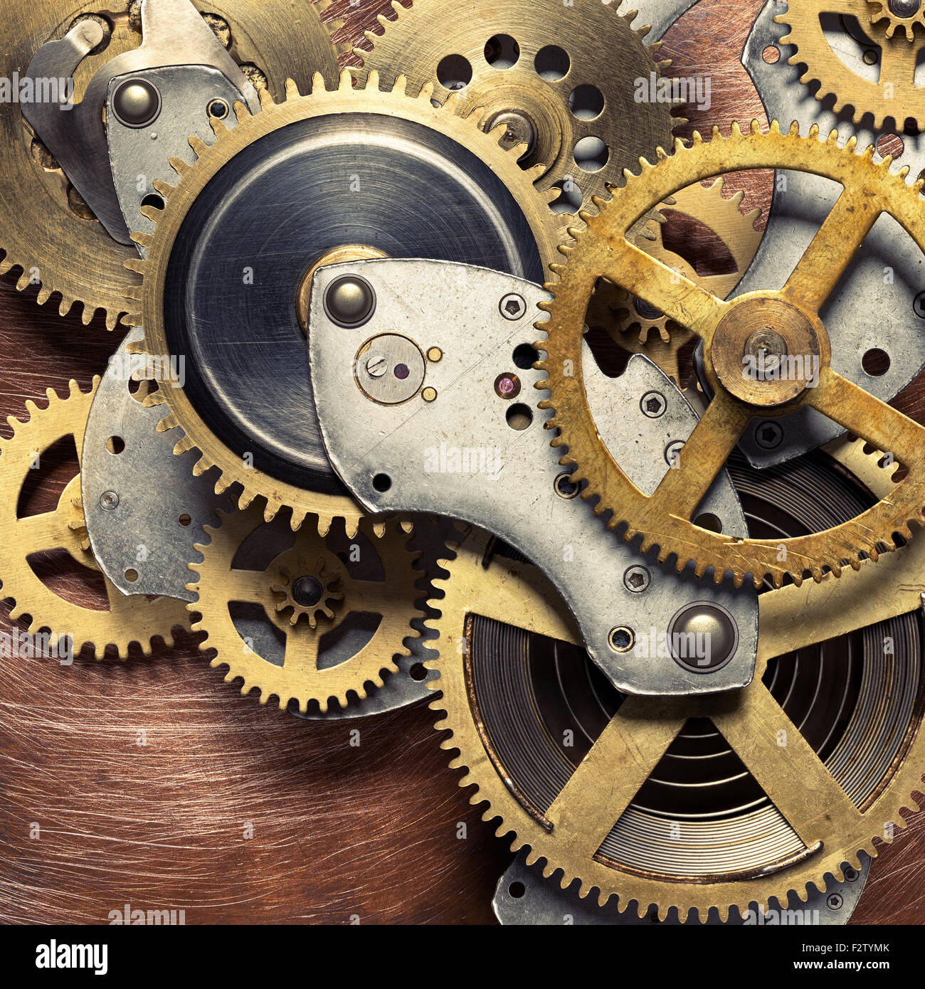 Metal collage of clockwork gears on copper background Stock Photo - Alamy