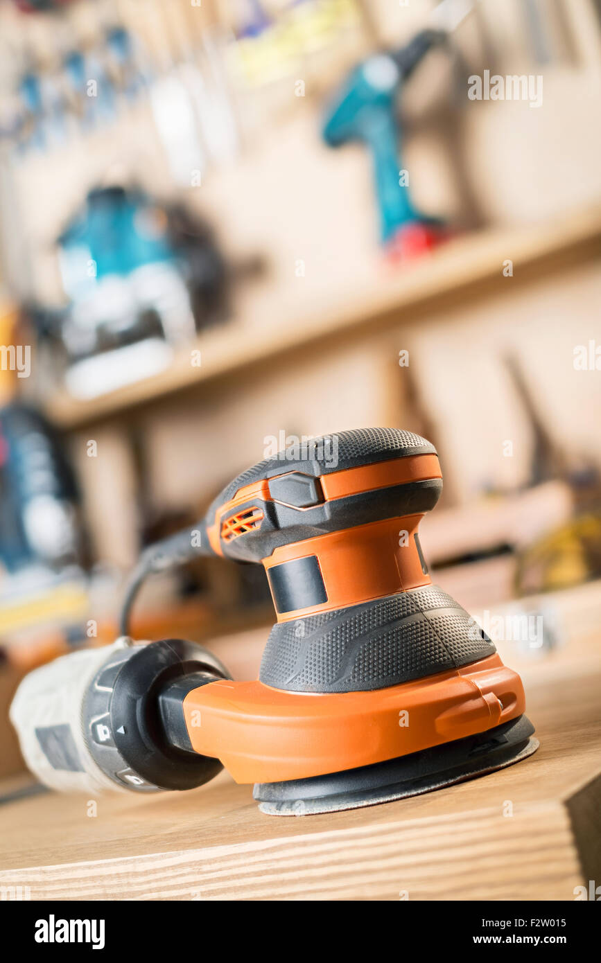 Sander on the table in a carpentry workshop or garage Stock Photo - Alamy
