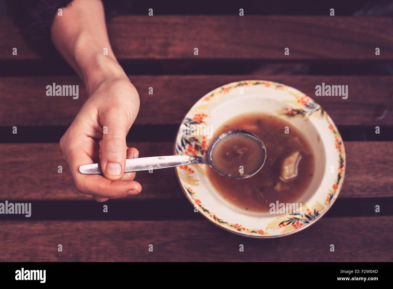 A Woman Is Holding A Spoon And Eating Soup Closeup On Her Hand Stock