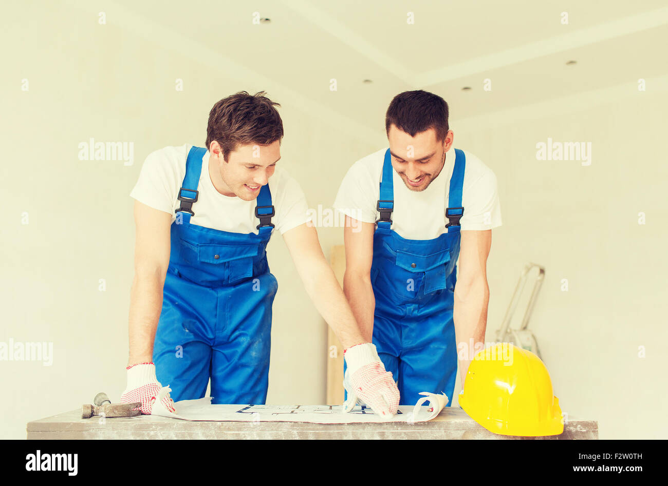 group of builders with blueprint Stock Photo - Alamy