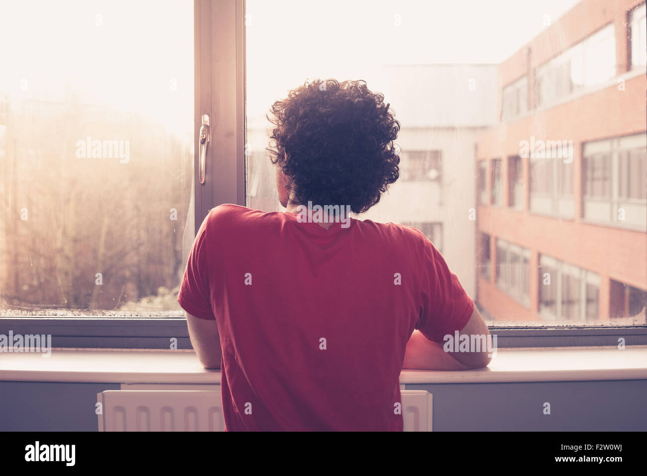 Lonely man looking out of window hi-res stock photography and images ...