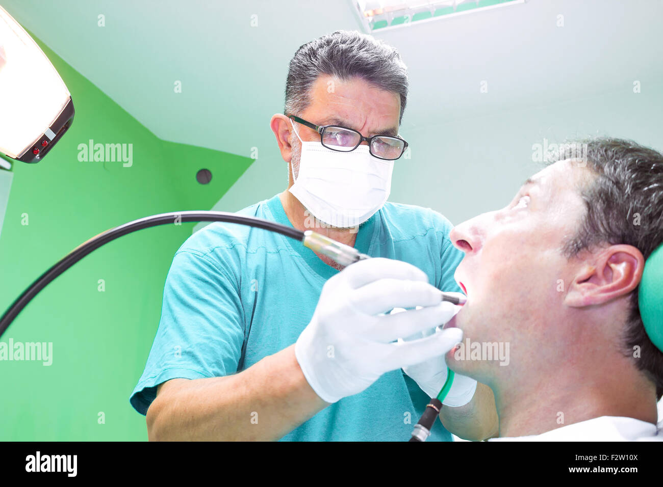 Mending patient's teeth Stock Photo - Alamy