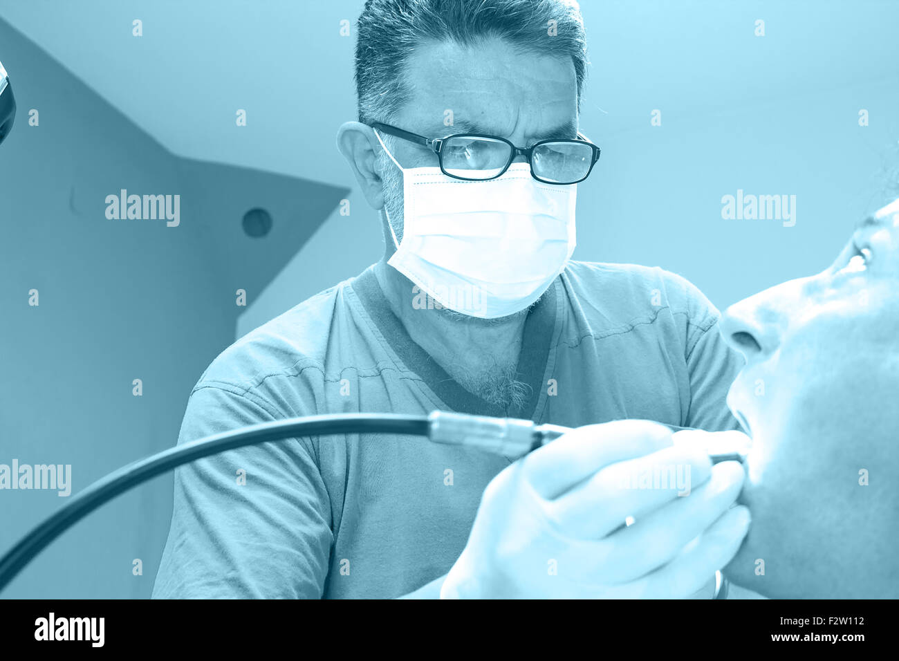 Mending patient's teeth Stock Photo - Alamy