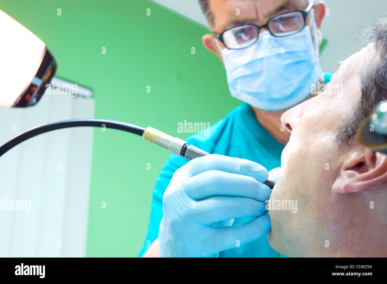 Mending patient's teeth Stock Photo - Alamy