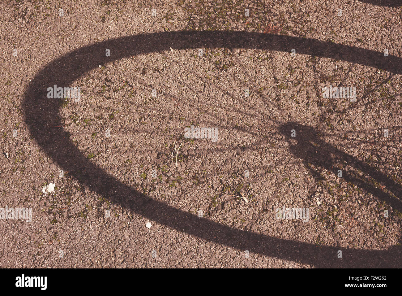 The shadow of a bike wheel Stock Photo - Alamy