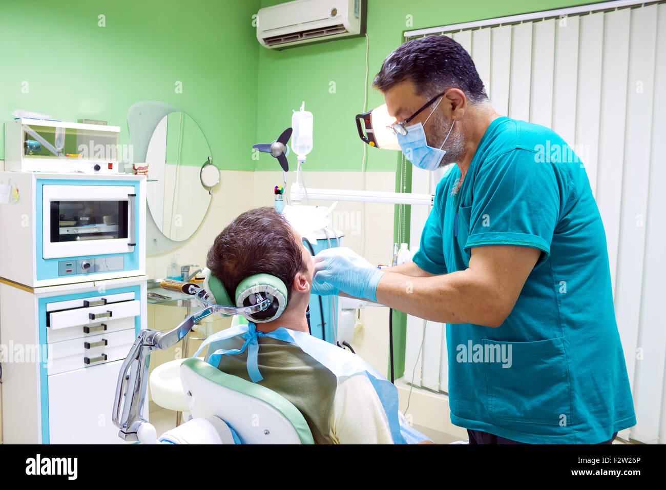 Mending patient's teeth Stock Photo - Alamy