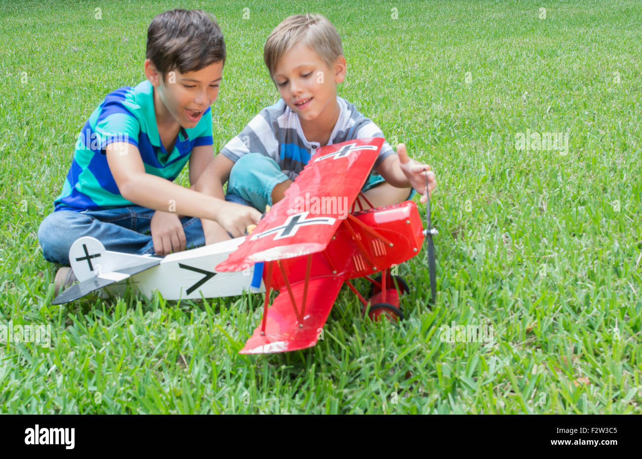 Two young boys playing with a model plane German Fokker DII from WWI in ...
