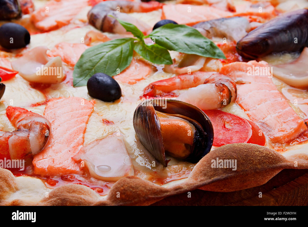 Pizza with seafood mussel and salmon fish Stock Photo - Alamy