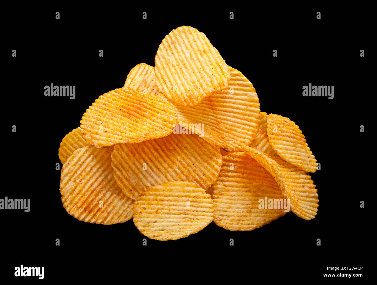 Potato ripple chips snack isolated on black background Stock Photo - Alamy