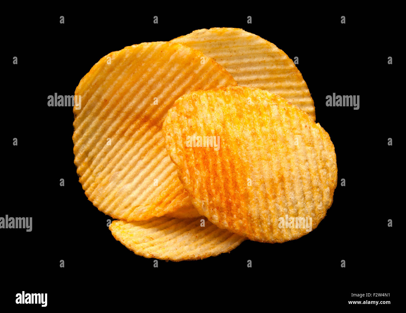 Potato ripple chips snack isolated on black background Stock Photo - Alamy