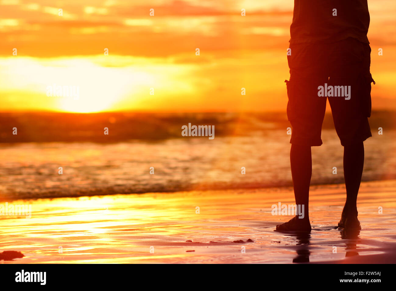 man with a sunset on the beach Stock Photo - Alamy
