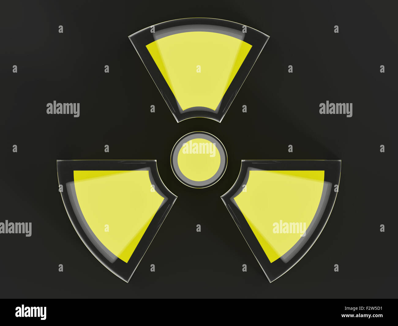 Clear glass black and yellow nuclear symbol isolated on a dark grey ...