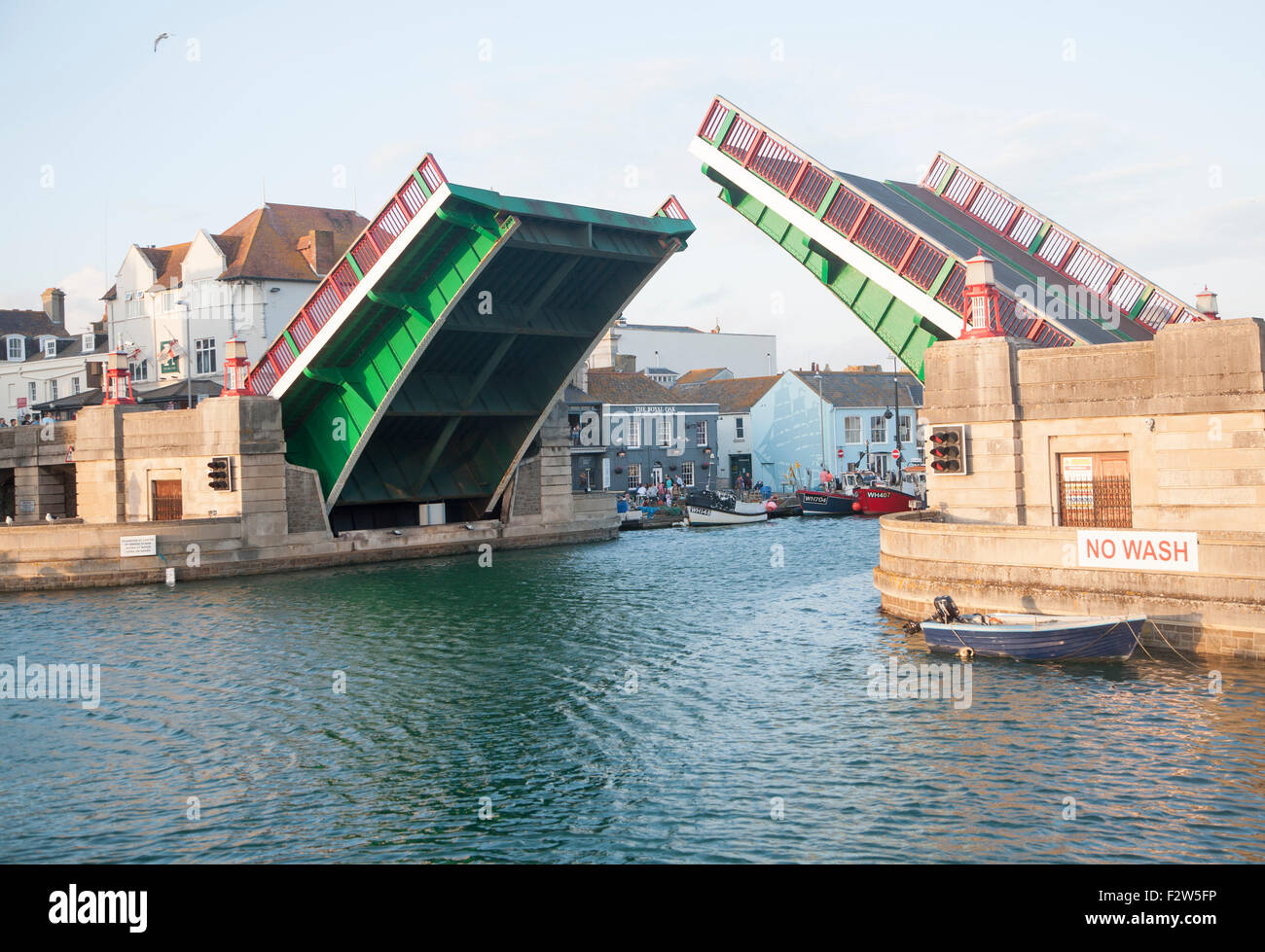 Town bridge raised to allow a yacht to pass into the marina in Weymouth ...