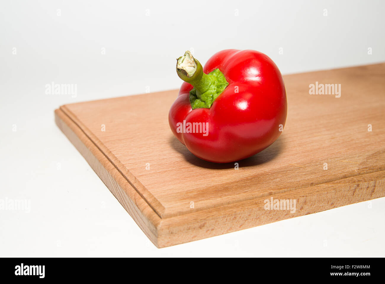 One red pepper on a white background Stock Photo - Alamy