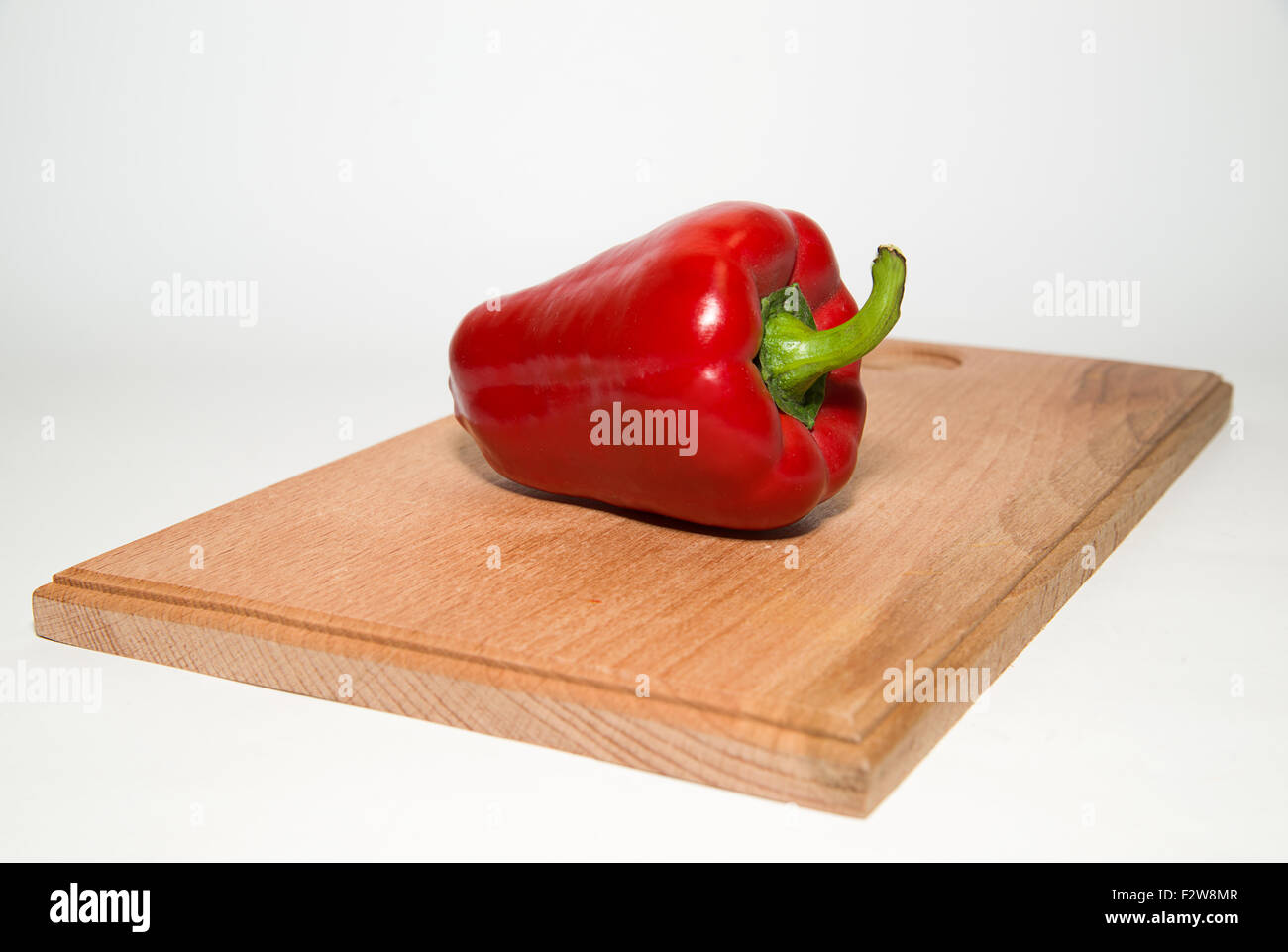 One red pepper on a white background Stock Photo - Alamy