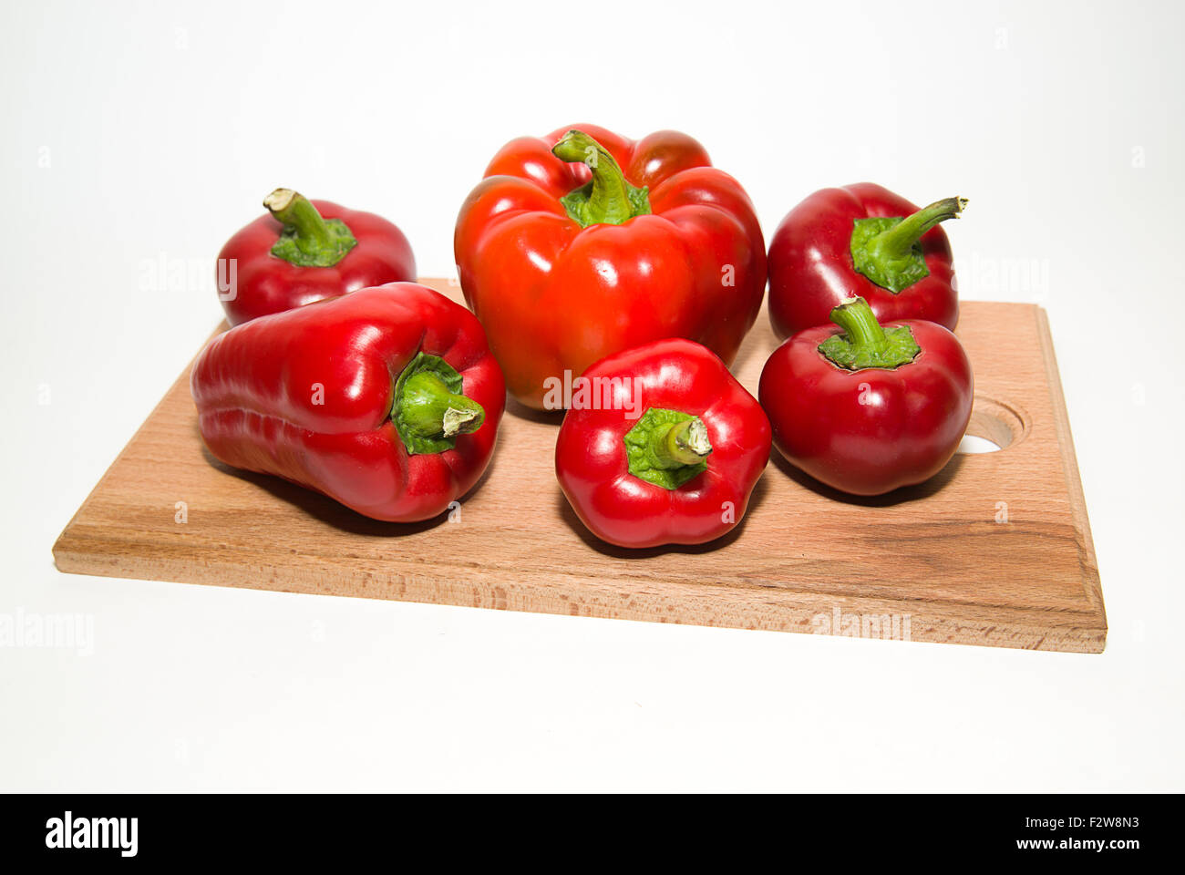 Many red peppers on a white background Stock Photo - Alamy
