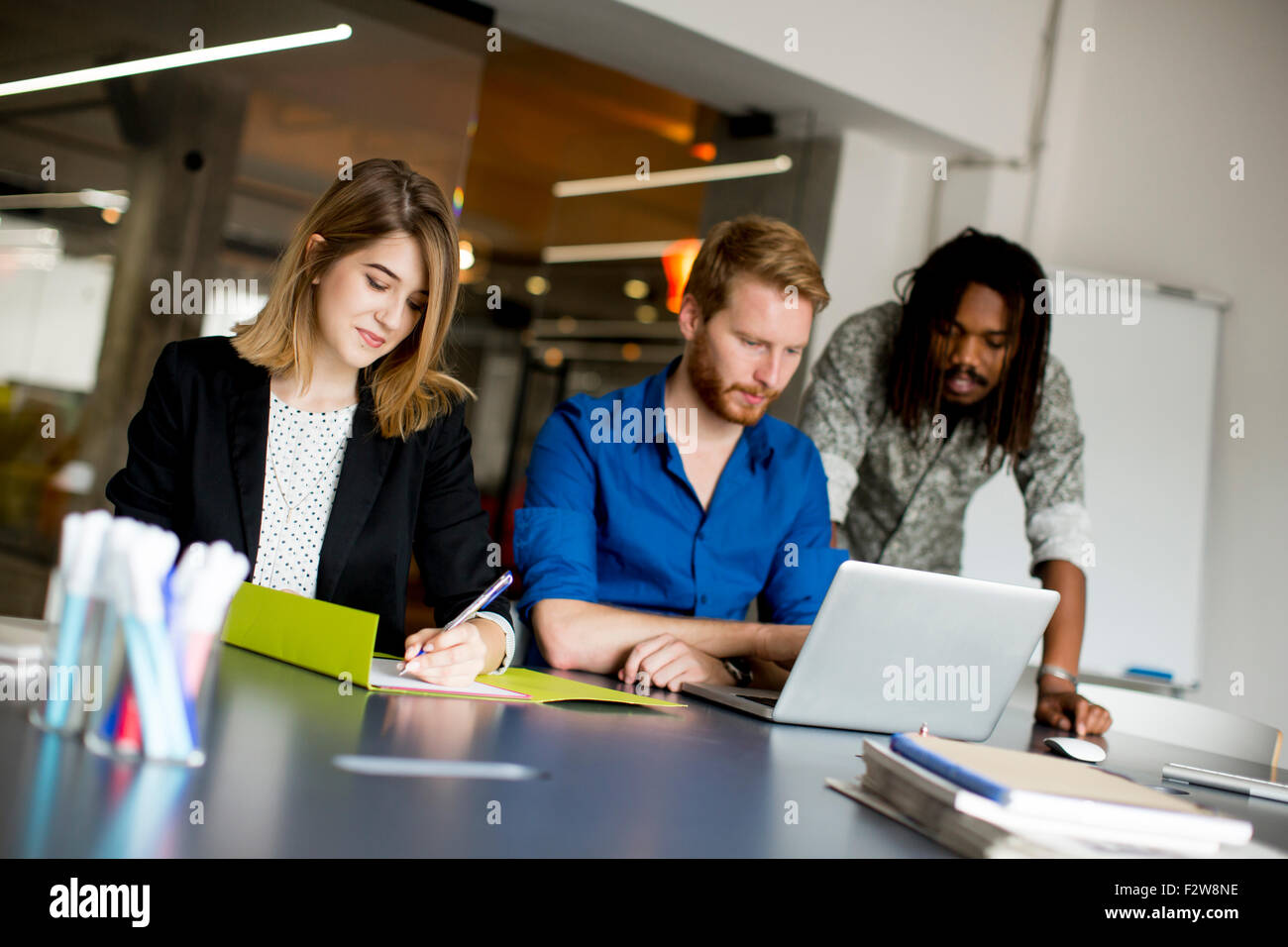 Young people in the office Stock Photo - Alamy