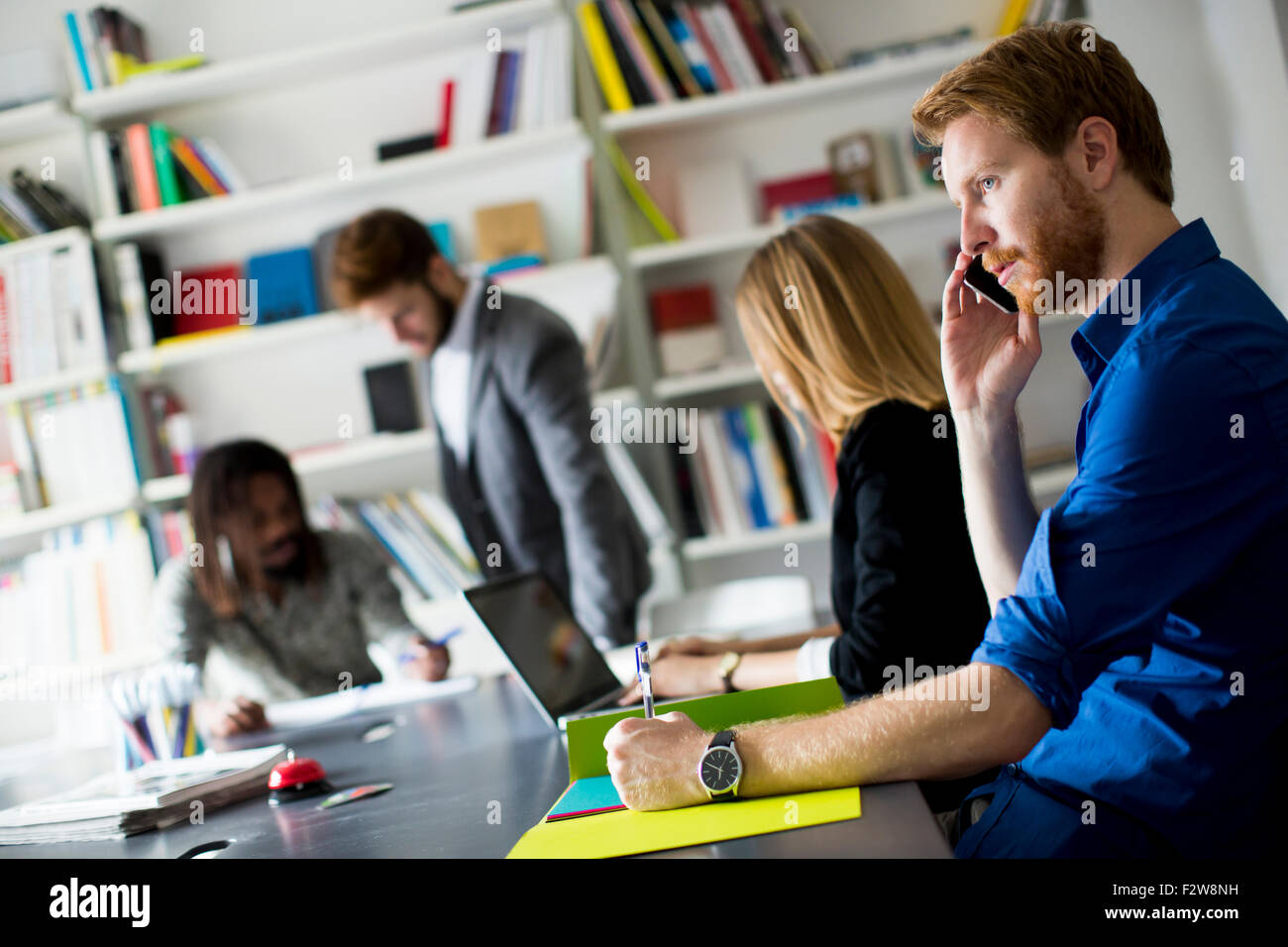 Young people in the office Stock Photo - Alamy
