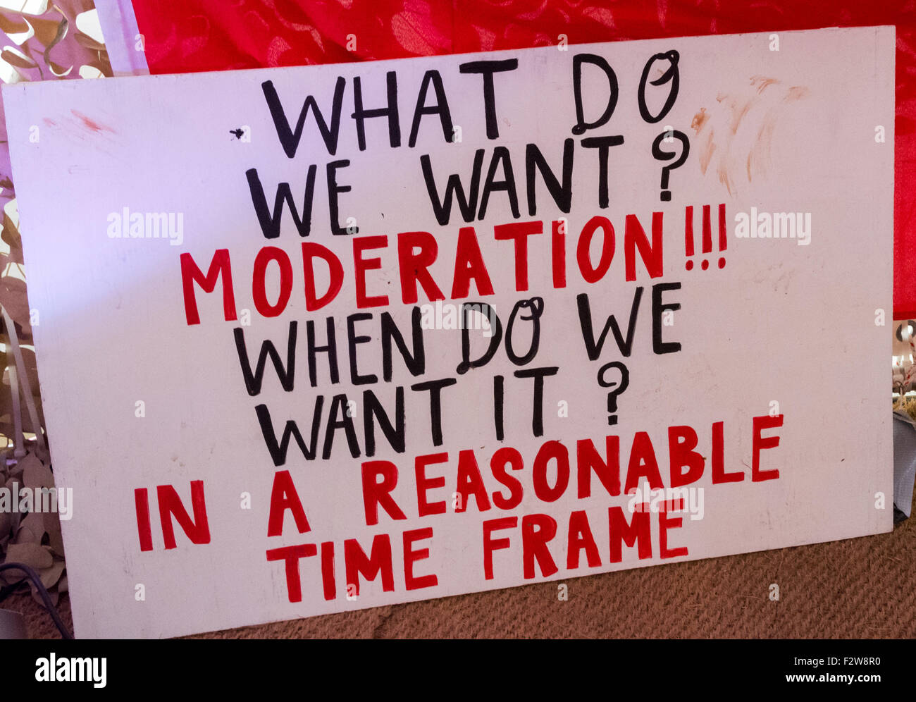 Banner at Banksy's Dismaland. What do we want? moderation Stock Photo ...
