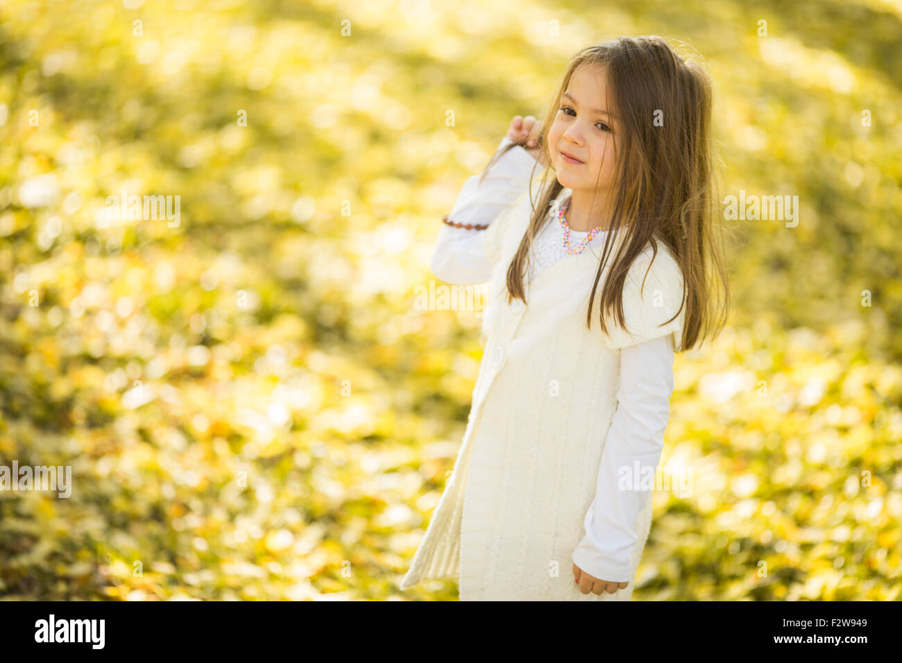 Little girl at the autumn park Stock Photo - Alamy
