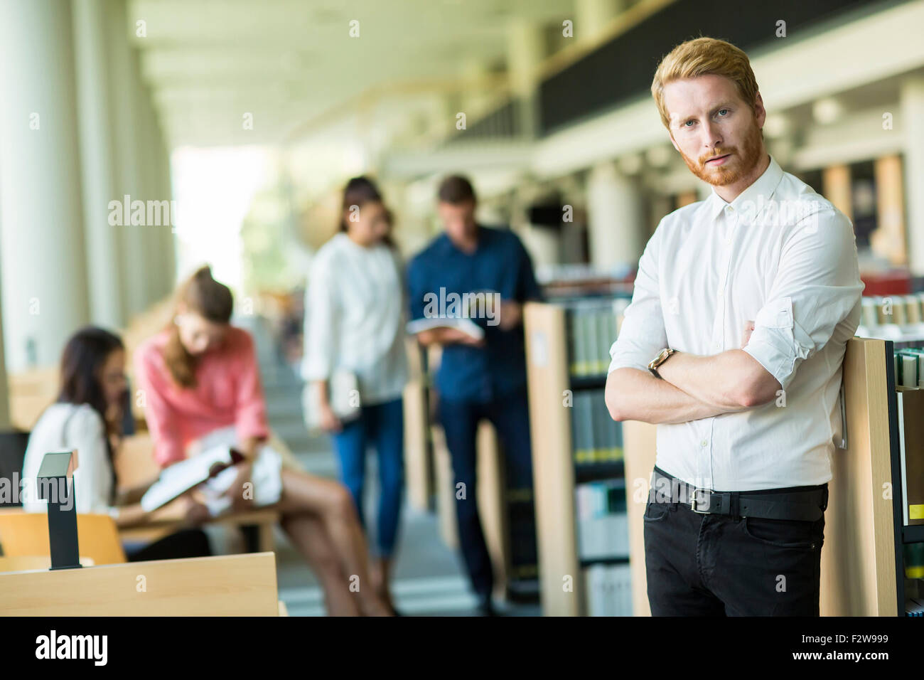 Young man in the library Stock Photo - Alamy
