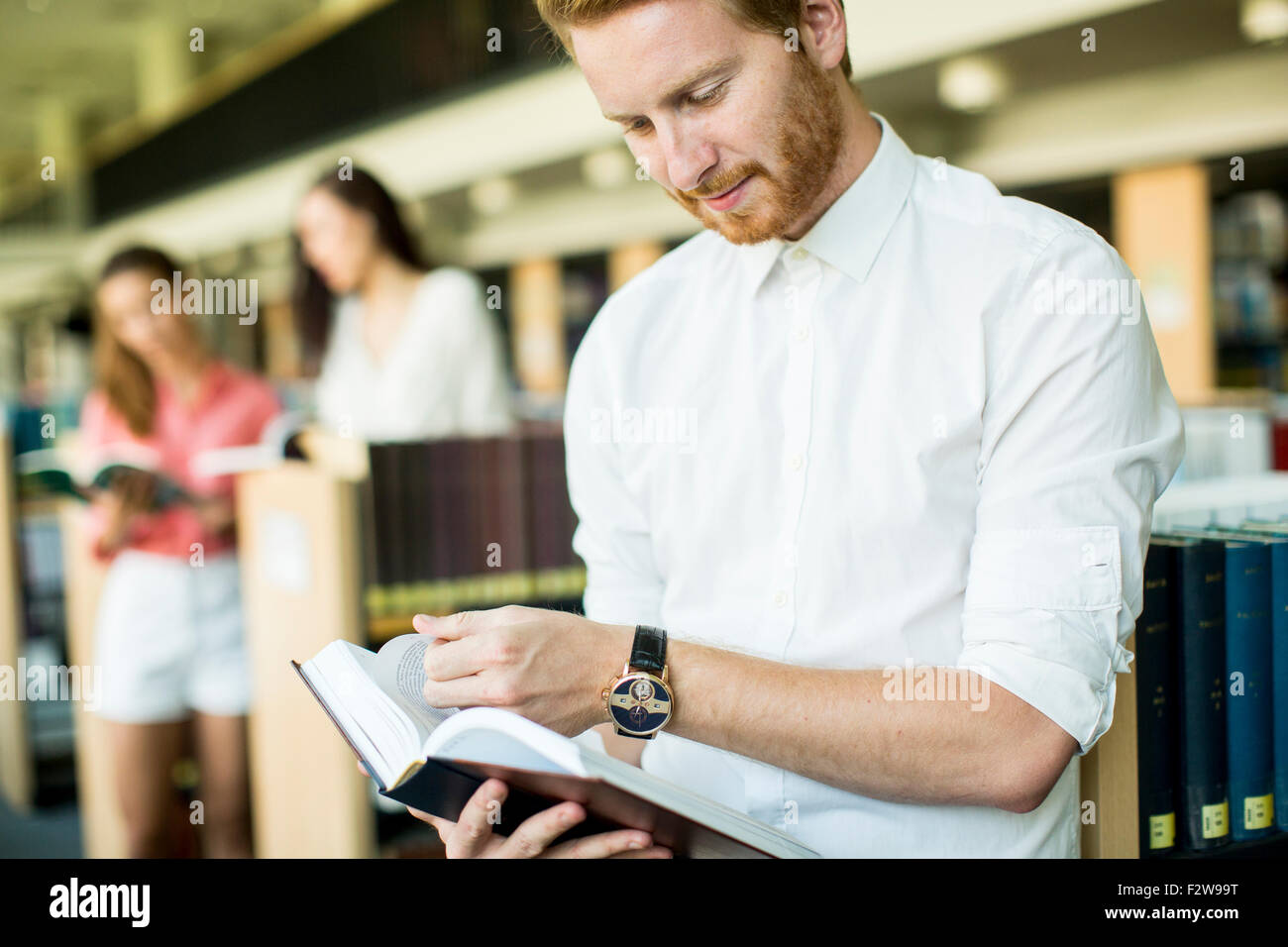 Young man in the library Stock Photo - Alamy