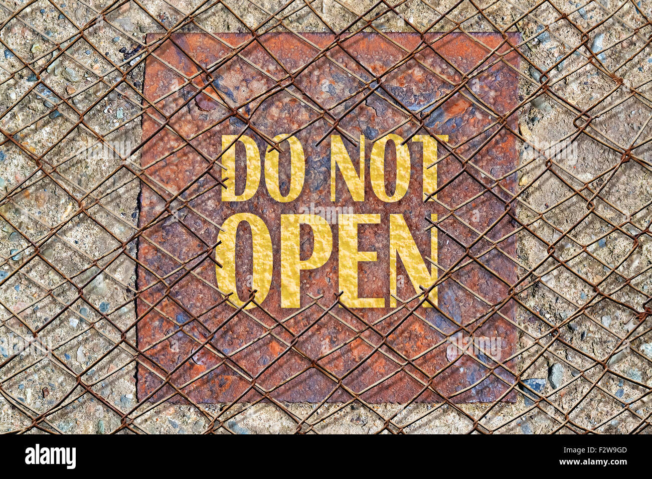 Text Do Not Open in golden color under a broken wire fence Stock Photo ...