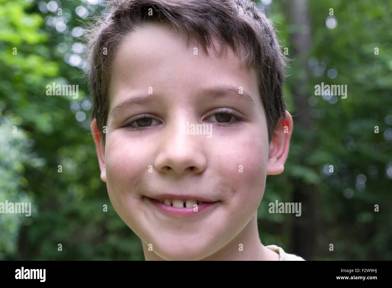 10 years old boy with happy look on his face, outdoor portrait Stock ...