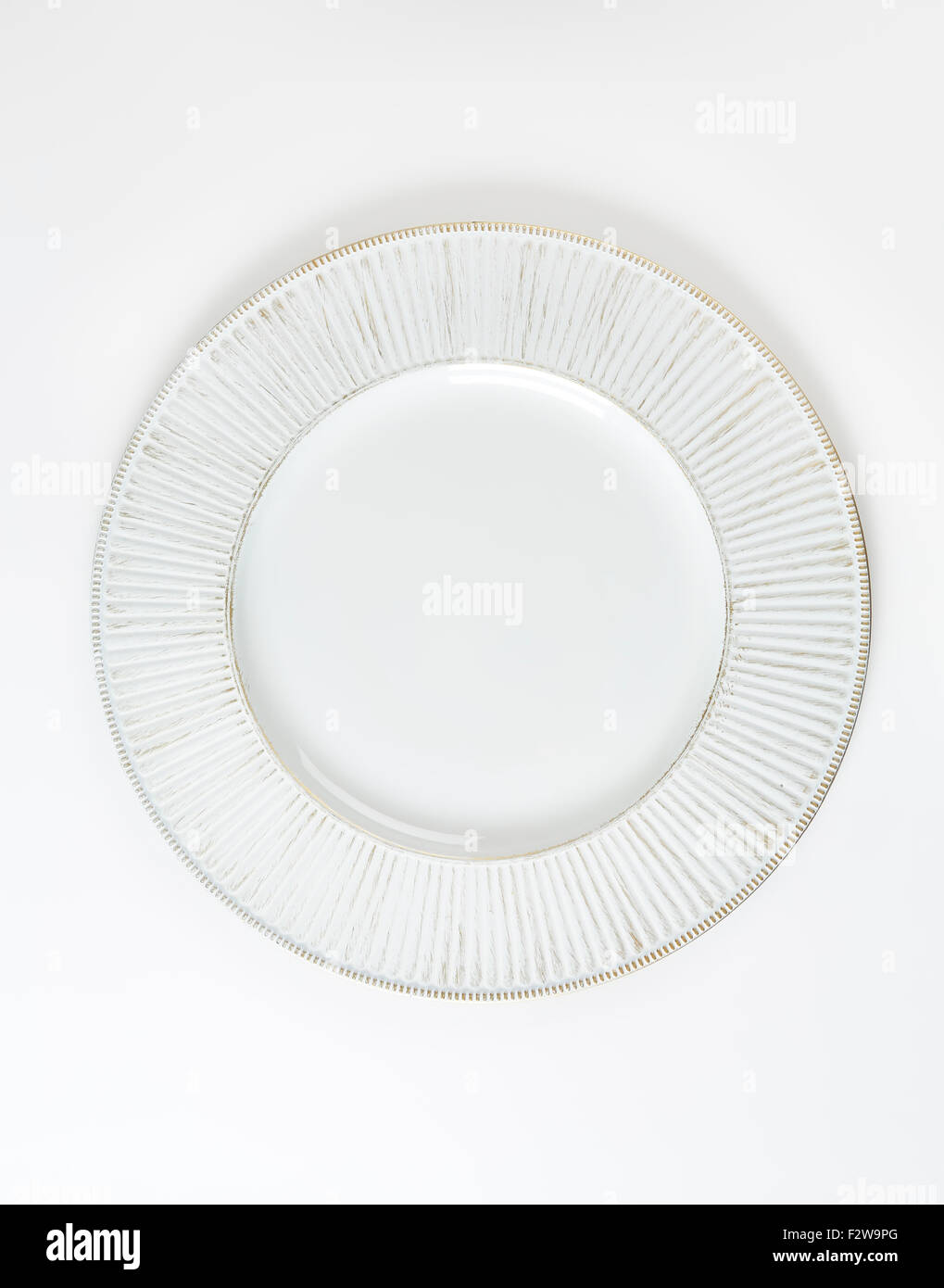 white plate with gold fluted rim on white background Stock Photo - Alamy