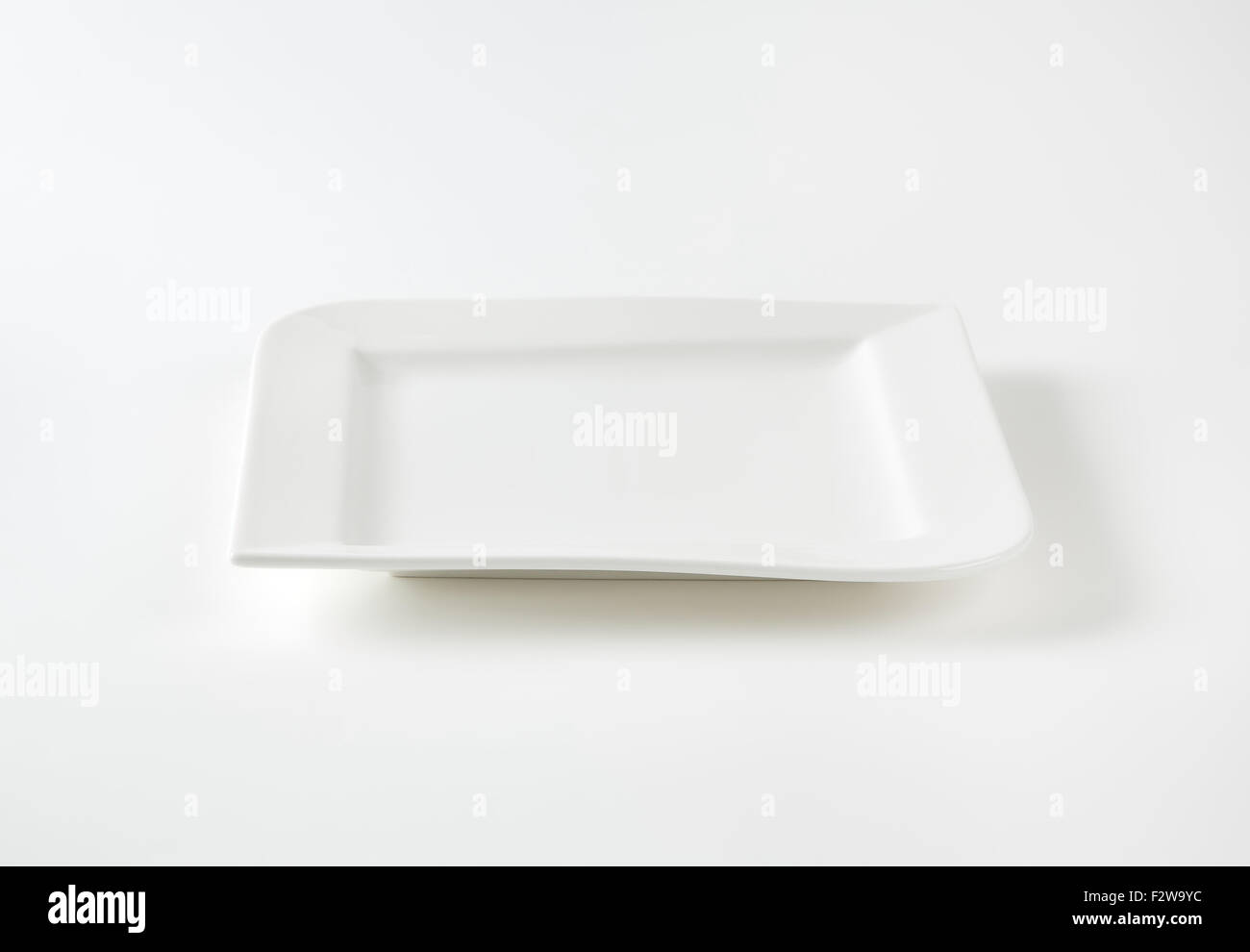 empty white square plate on white background Stock Photo - Alamy