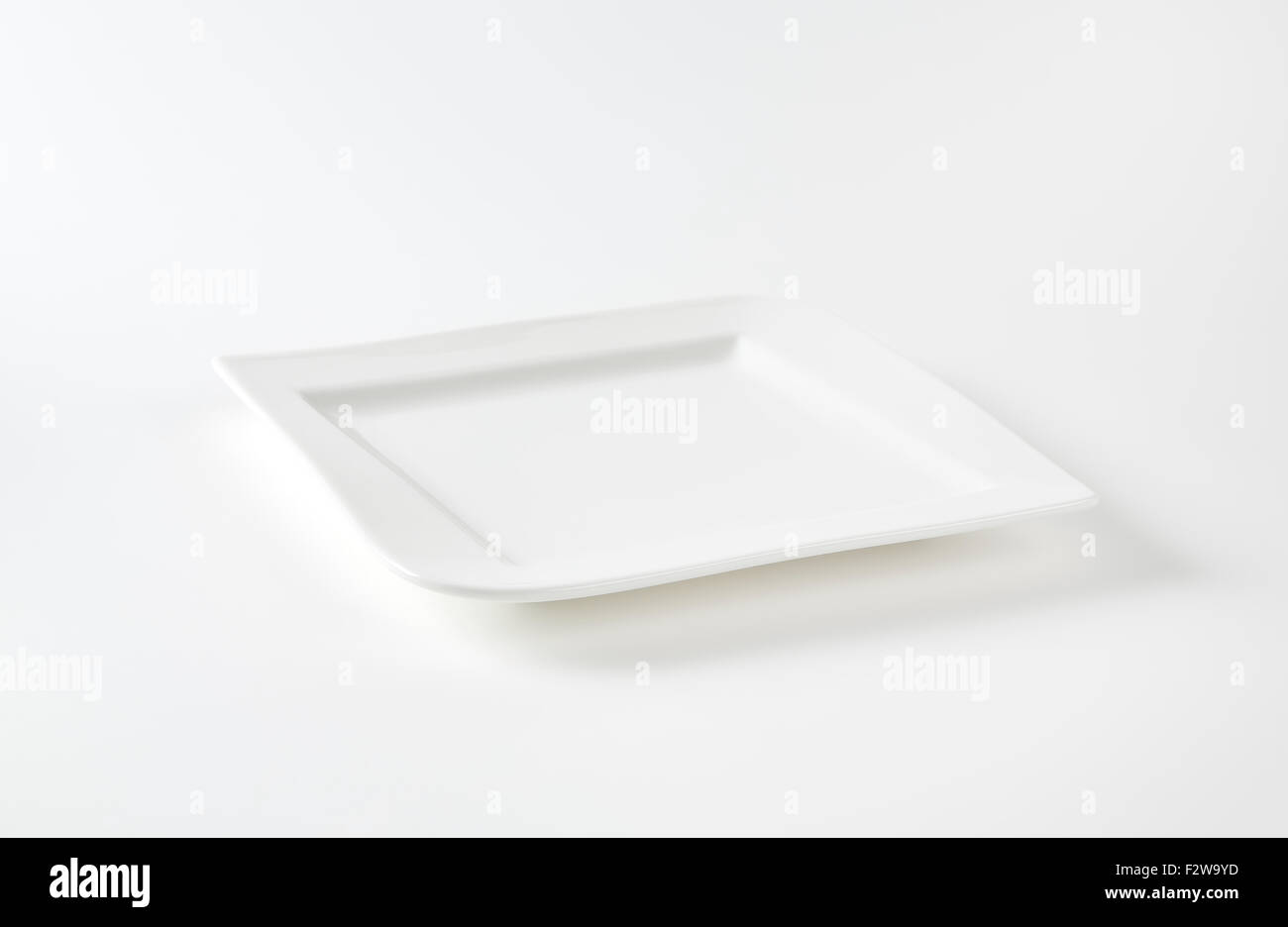 empty white square plate on white background Stock Photo - Alamy