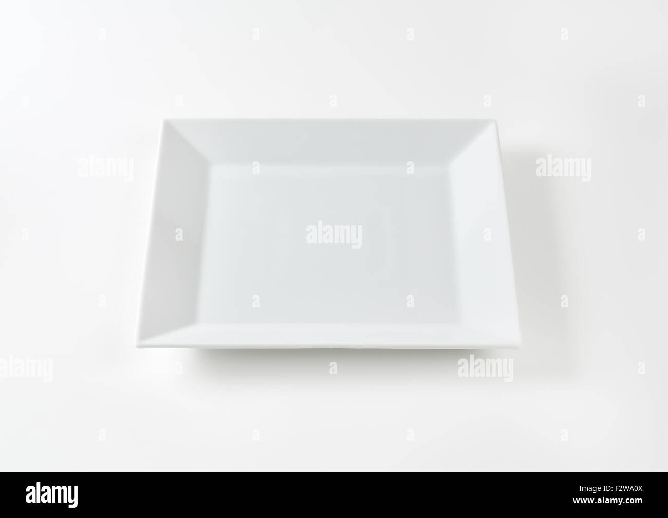 empty white square plate on white background Stock Photo - Alamy