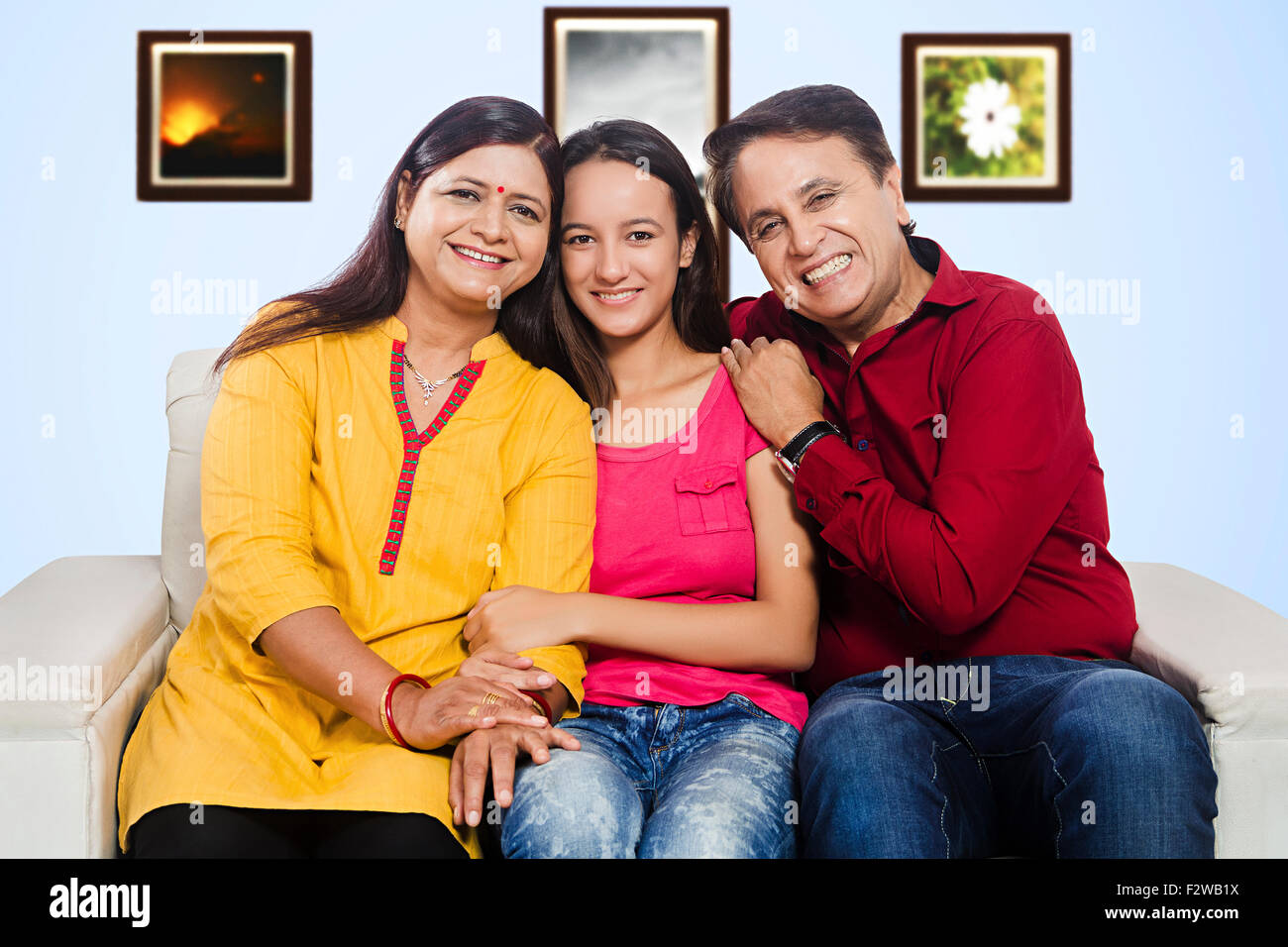 3 indian family Parents and young daughter sitting home Stock Photo - Alamy