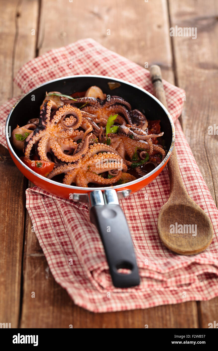 Italian food. Baby octopuses prepared with tomatoes, garlic and parsley ...
