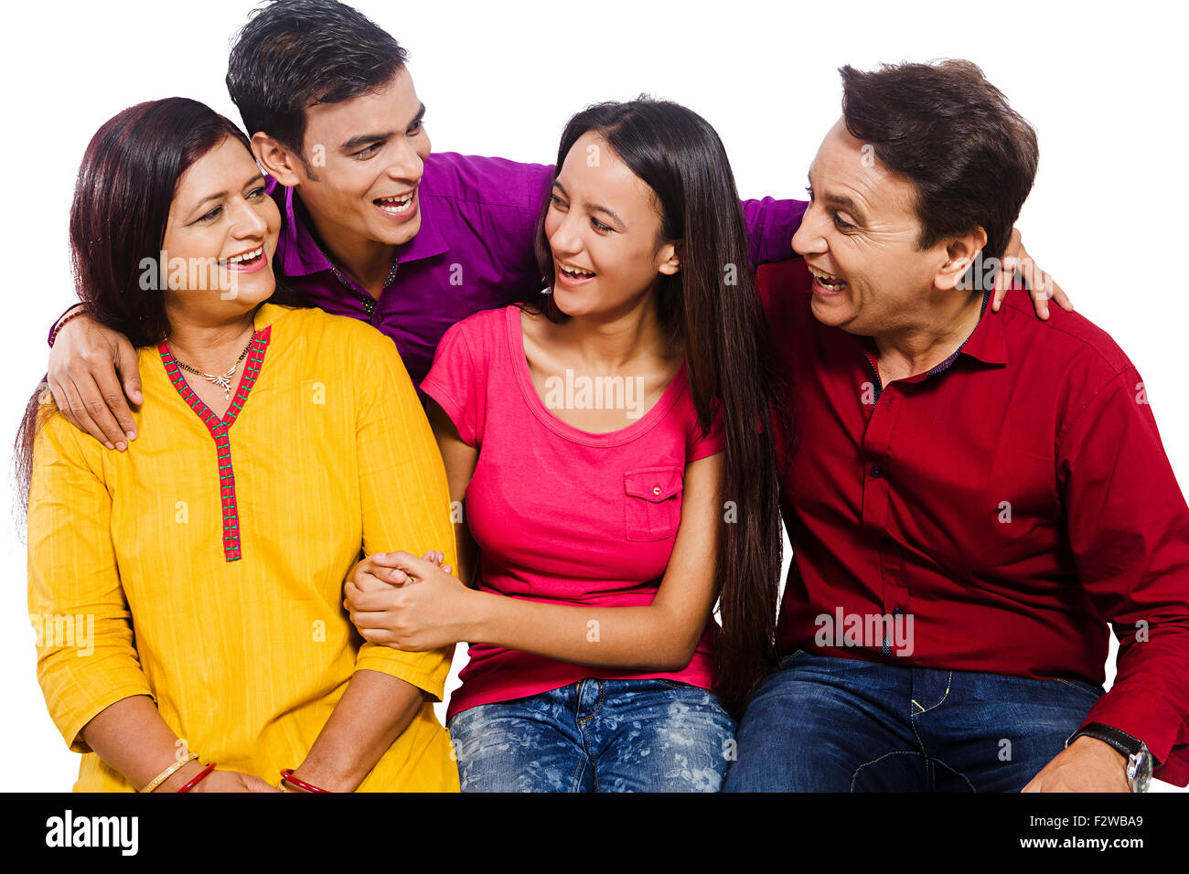 4 indian family Parents young daughter and son sitting home enjoy Stock ...
