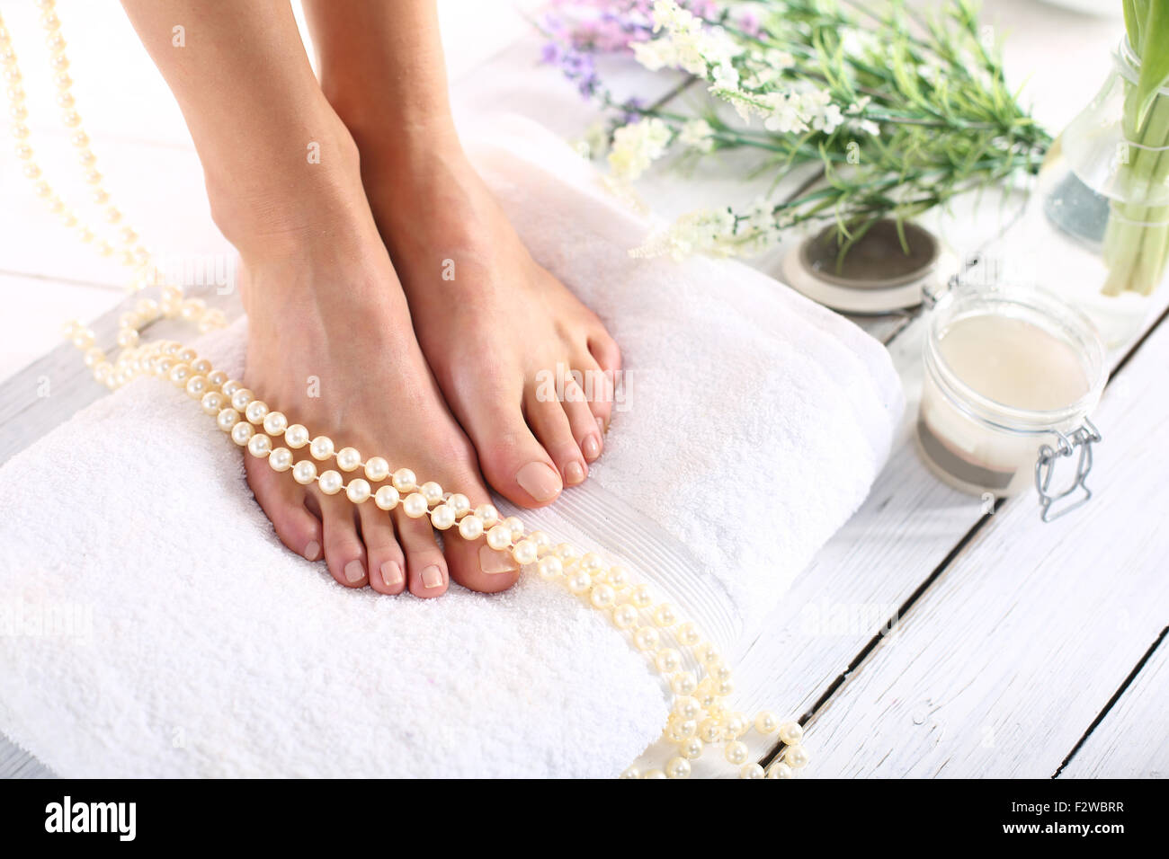 Women's feet. Luxury spa stupas. Beautiful female feet, smooth and neat ...