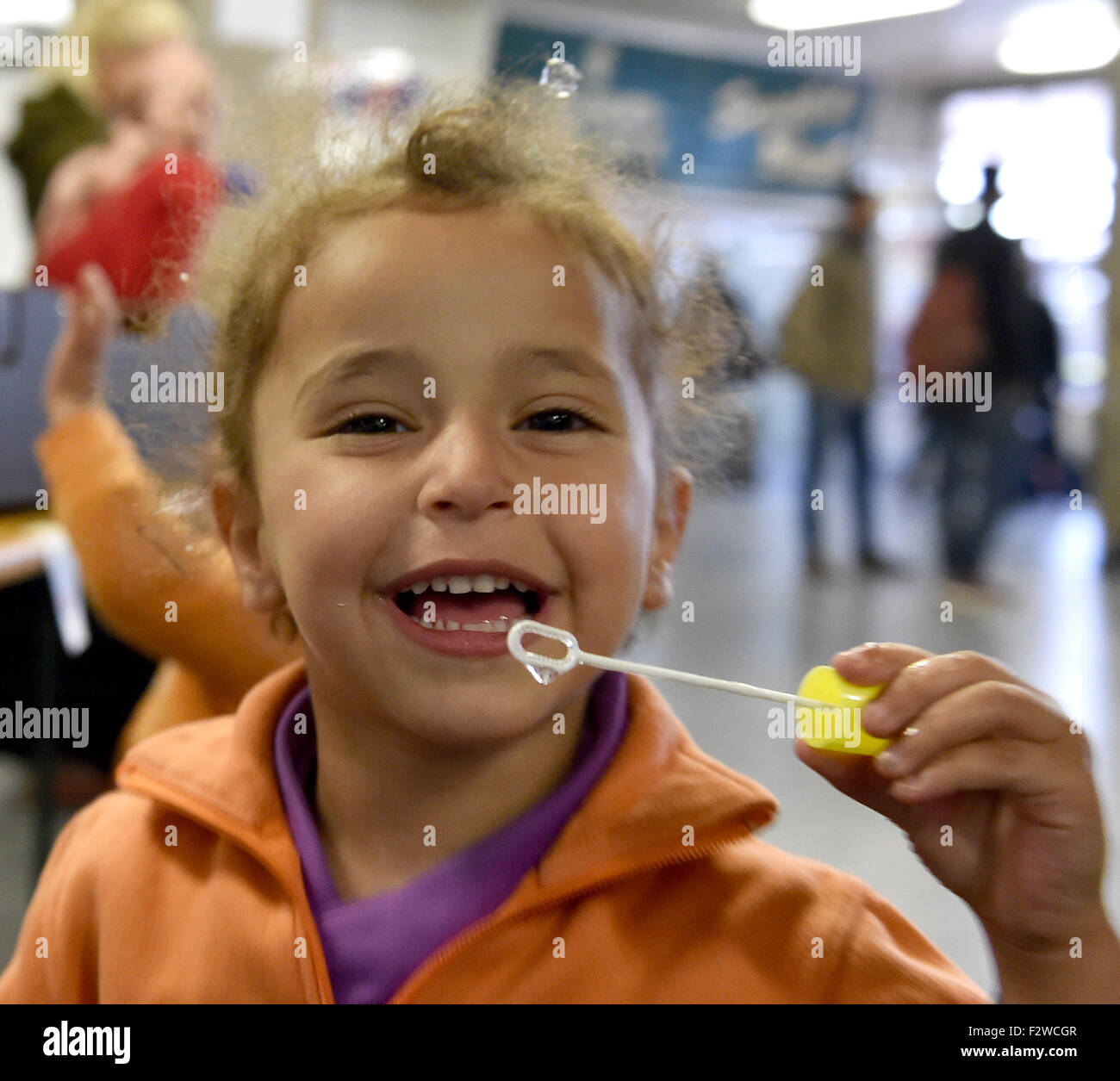 Manara from Syria blows bubbles after arriving in Schoenefeld, Germany ...