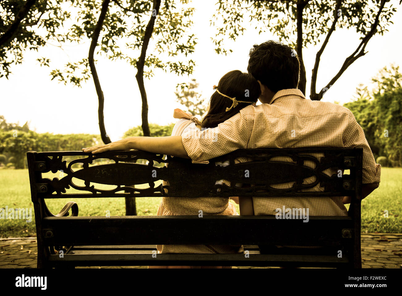 Backside of lover couples in the garden Stock Photo - Alamy