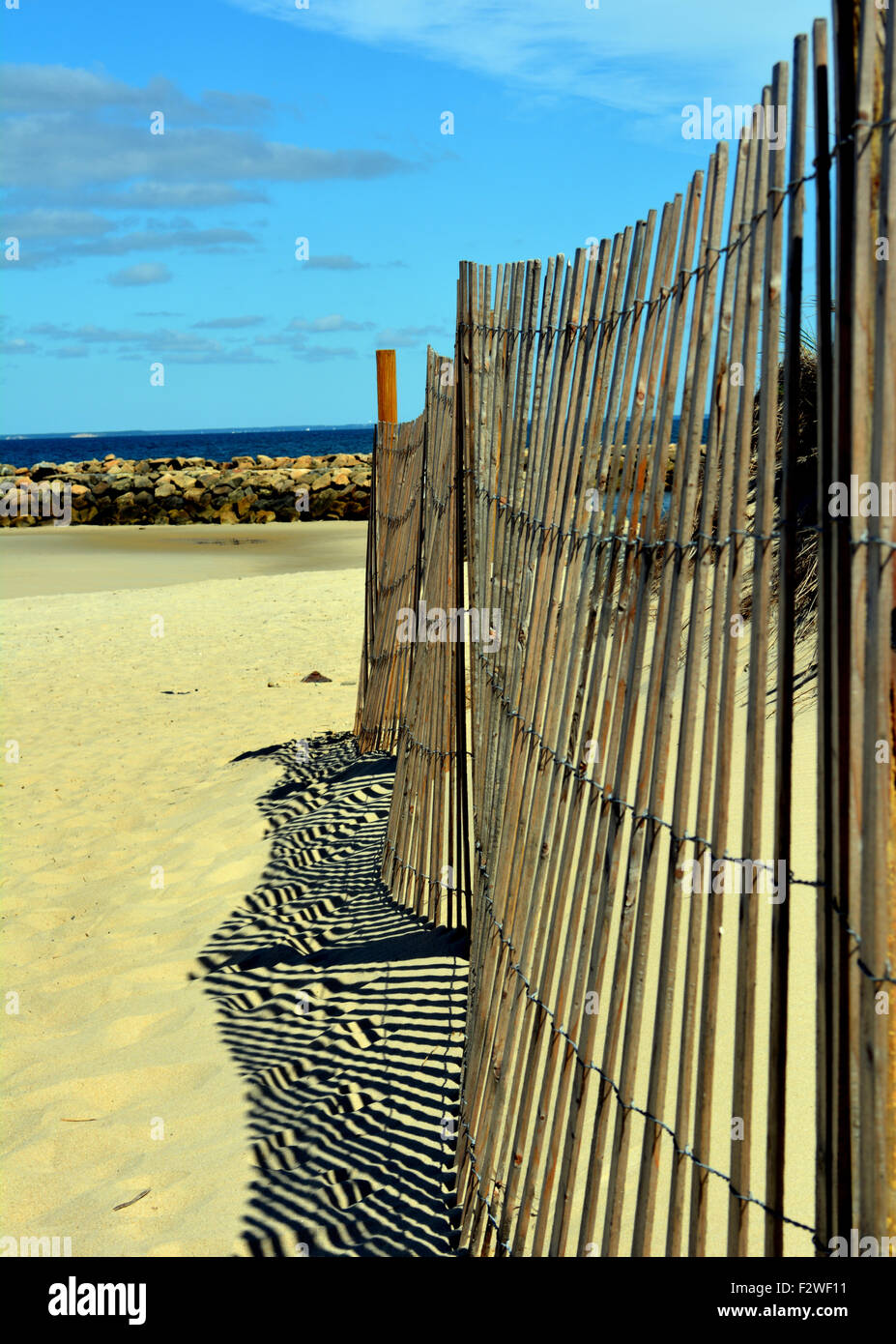 Fence leading to empty beach Stock Photo - Alamy