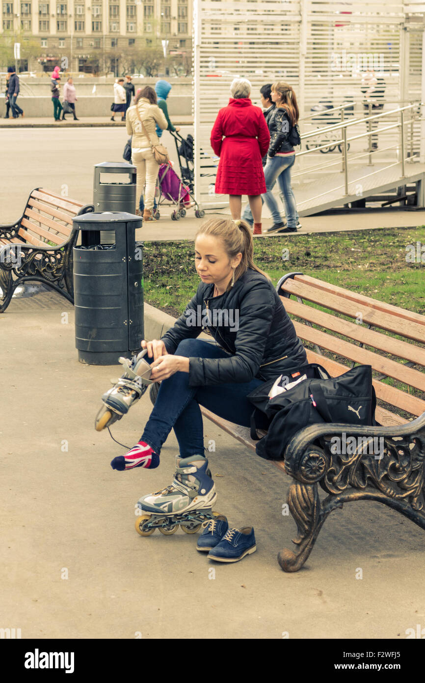 She puts on roller skates. Split toning Stock Photo - Alamy