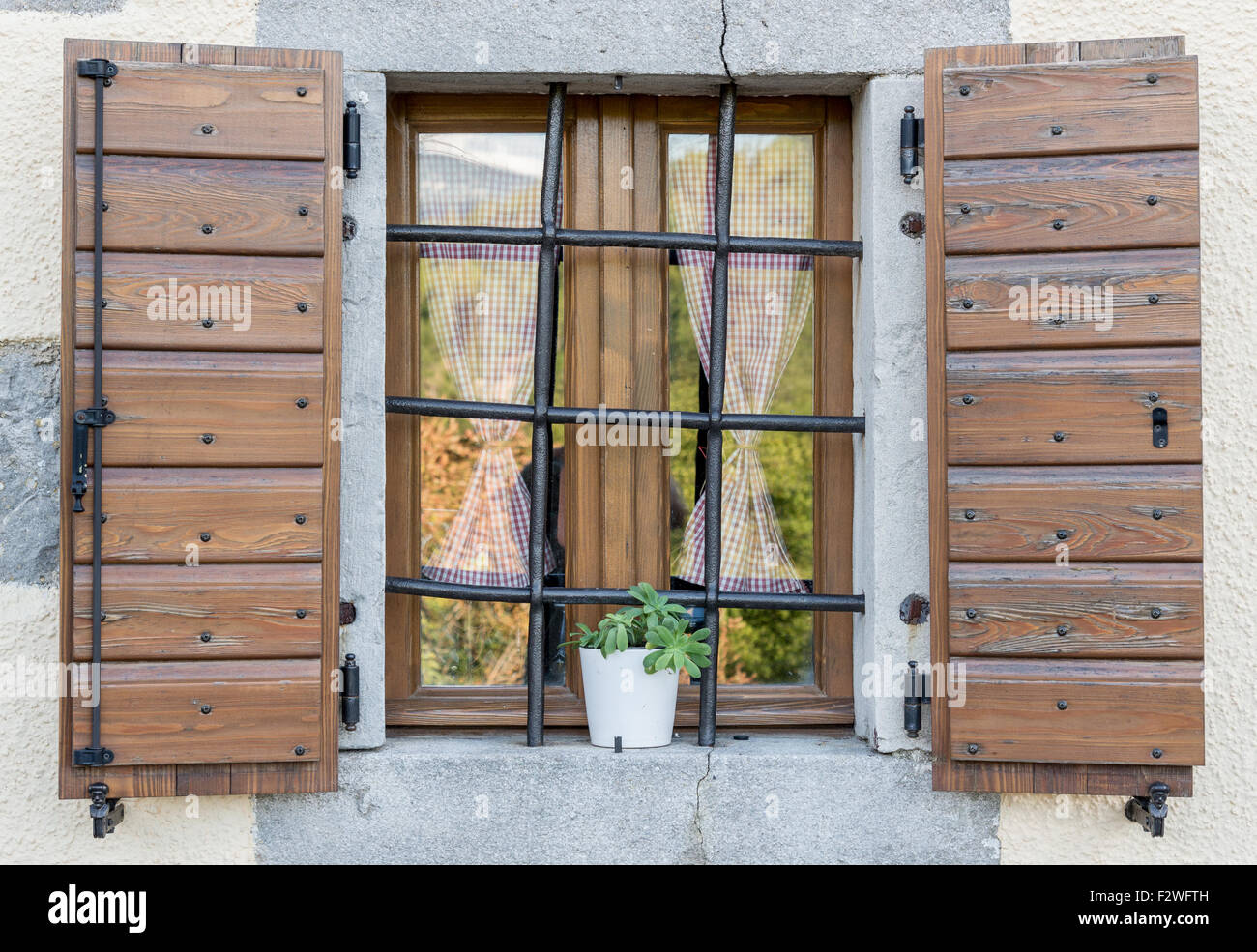 a nice window with open brown wooden shutters and curtains Stock Photo ...