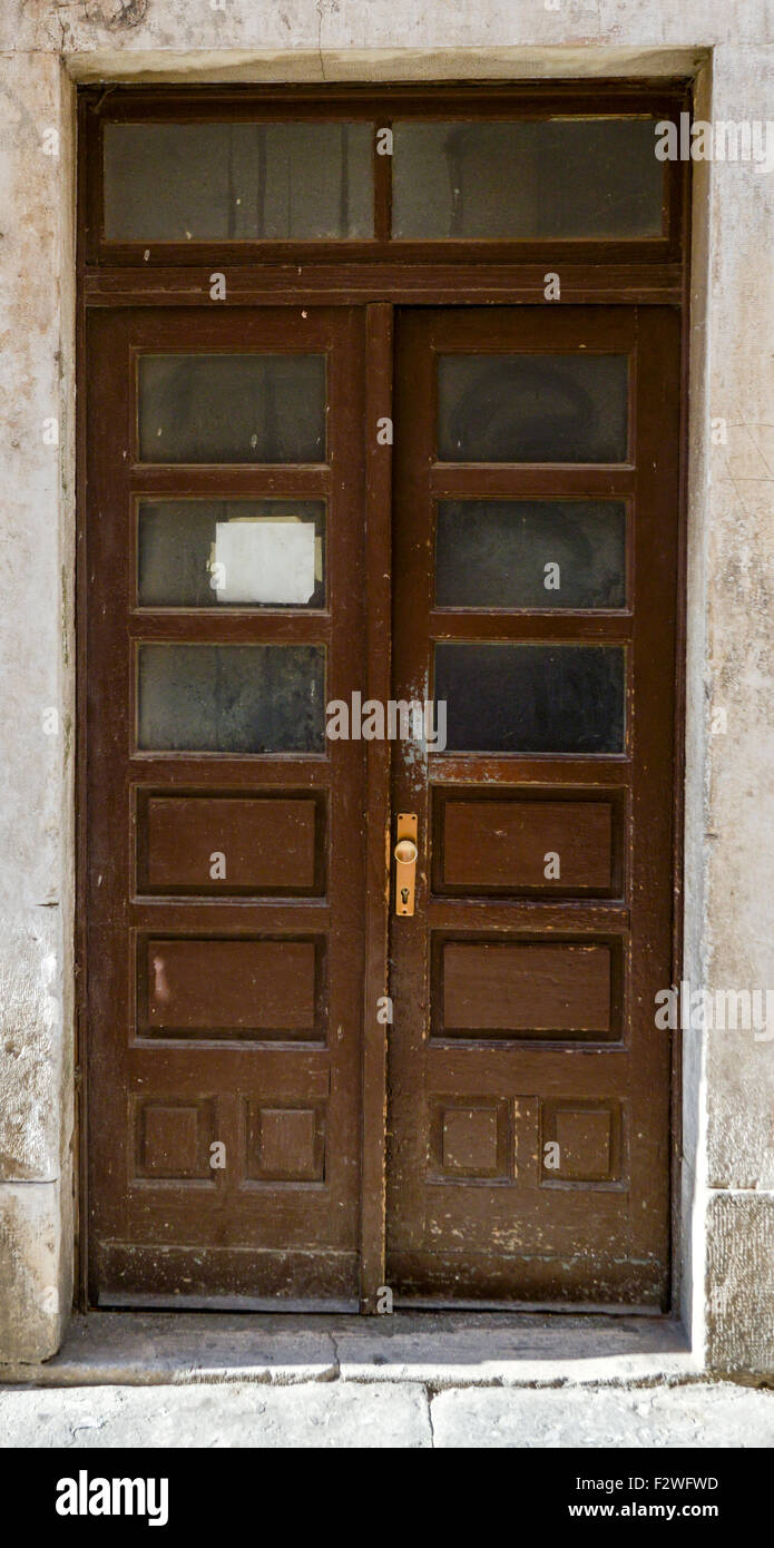 an old brown ragged shabby wooden door Stock Photo - Alamy