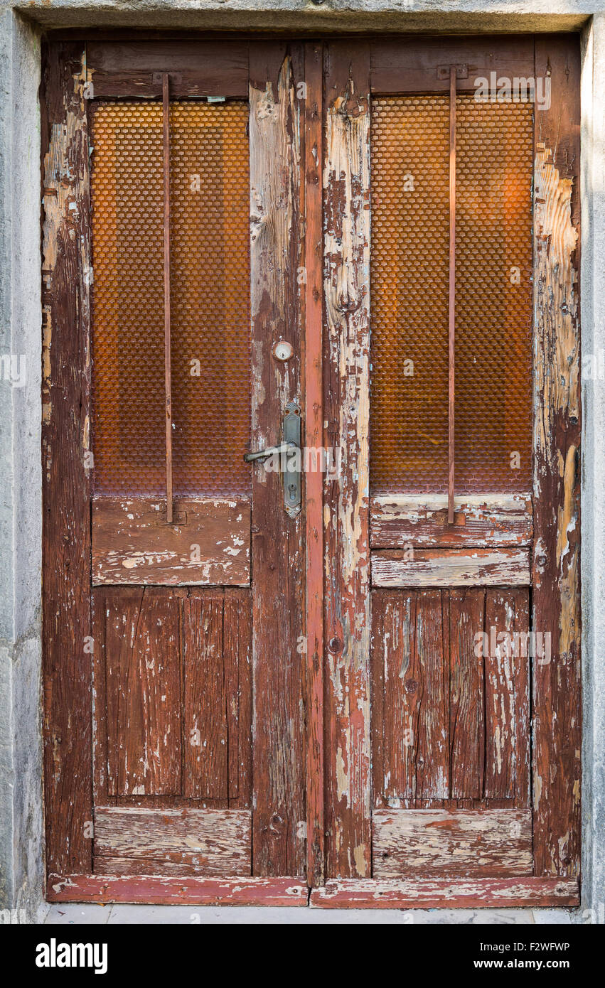 an old brown ragged shabby wooden door Stock Photo - Alamy