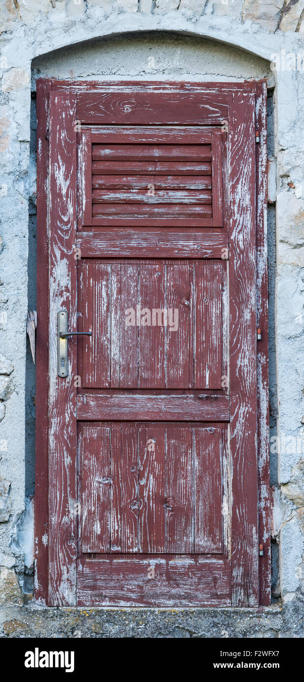 an old brown yellow ragged shabby wooden door Stock Photo - Alamy