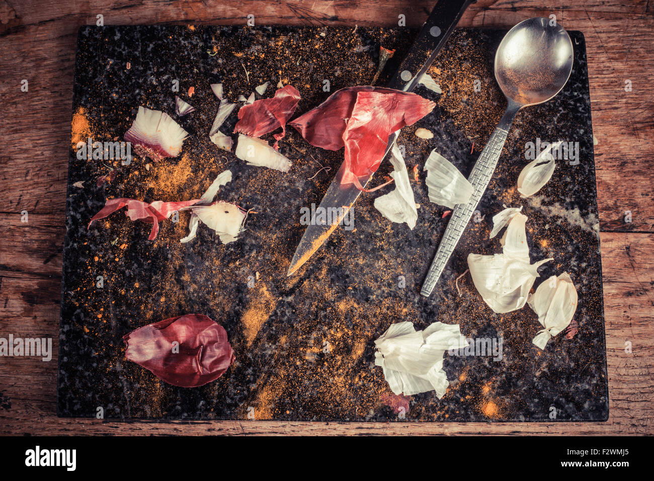 Knife and spoon on a dirty chopping board with spices Stock Photo - Alamy
