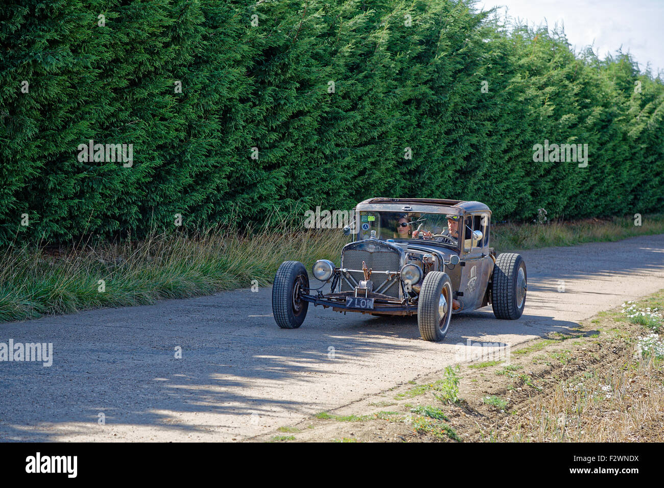 A couple in a 'chopped' heavily modified early Ford American two door ...