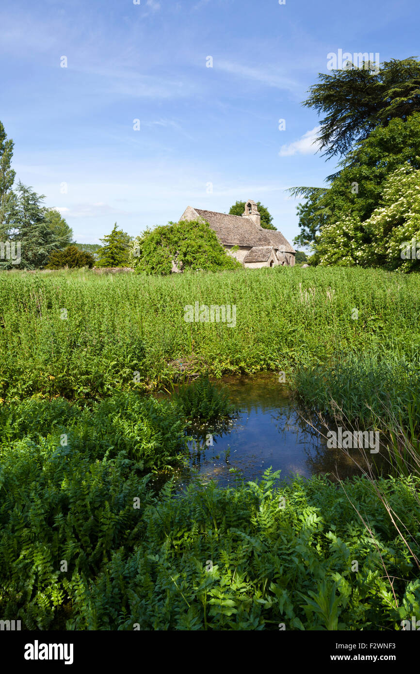 The Ampney Brook flowing past the Norman church of St Mary in the ...