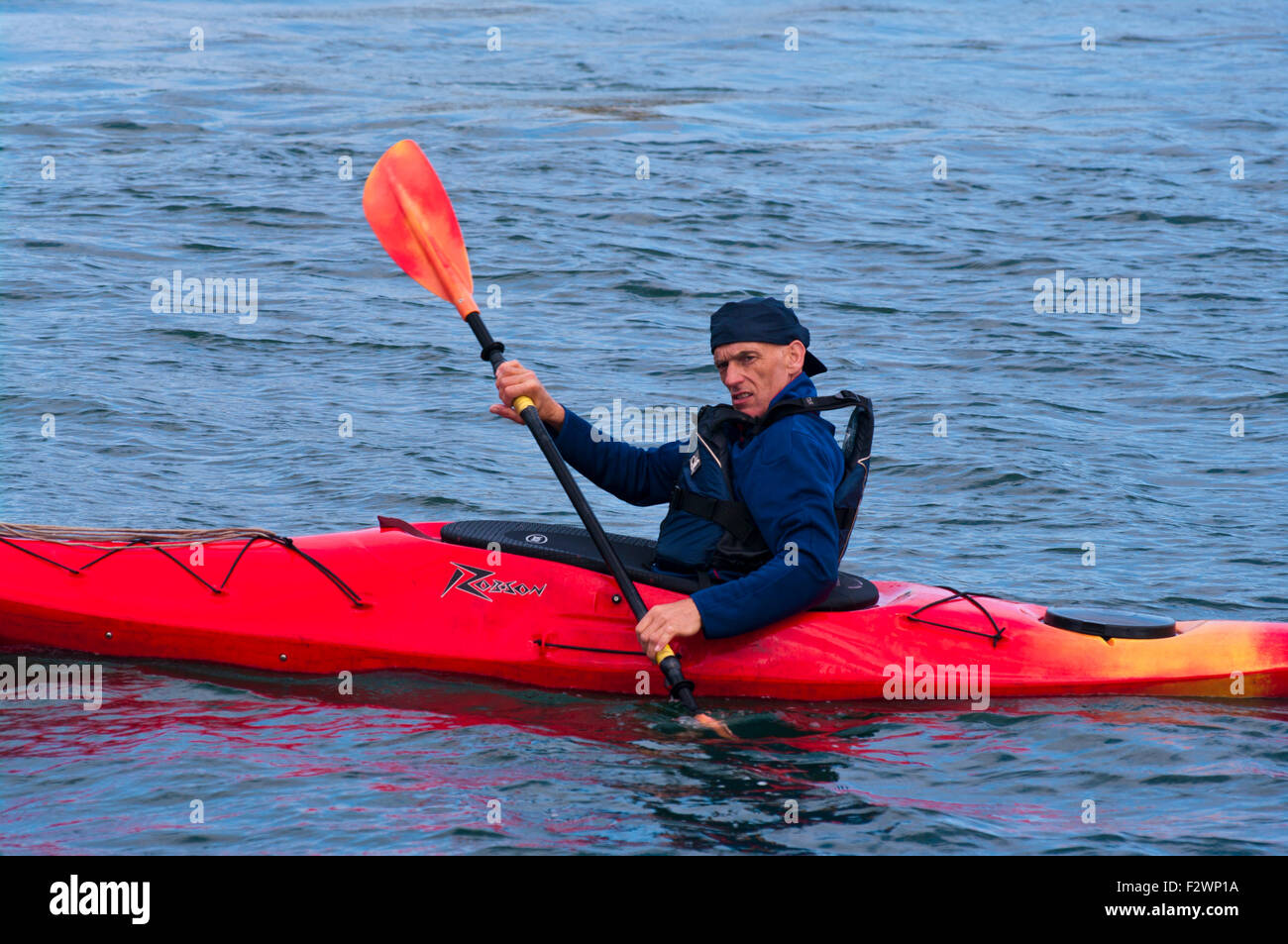 Side View Of A Person Paddling a Red Robson Kayak Stock Photo - Alamy