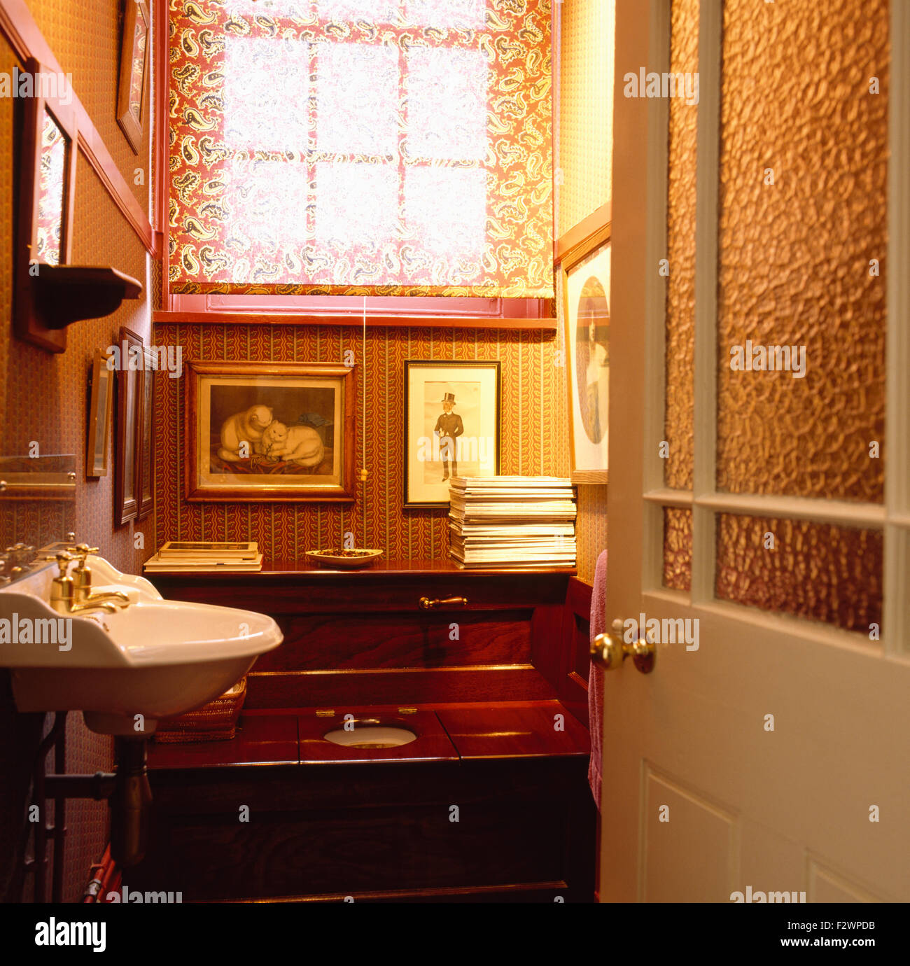 Door open to Edwardian style cloakroom Stock Photo - Alamy