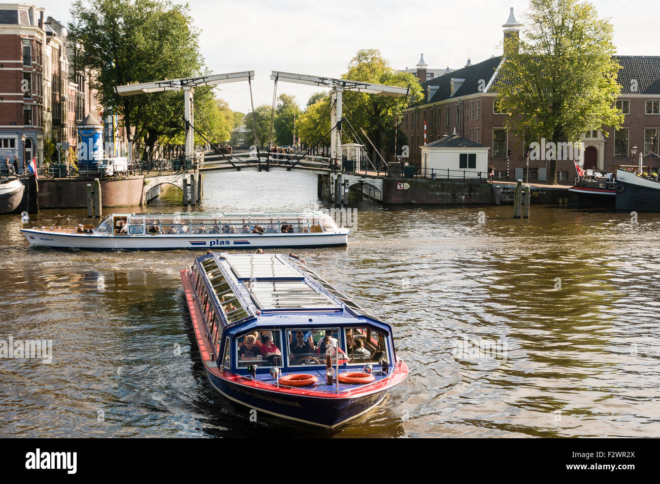 Sightseeing canal boats in Amsterdam Stock Photo - Alamy